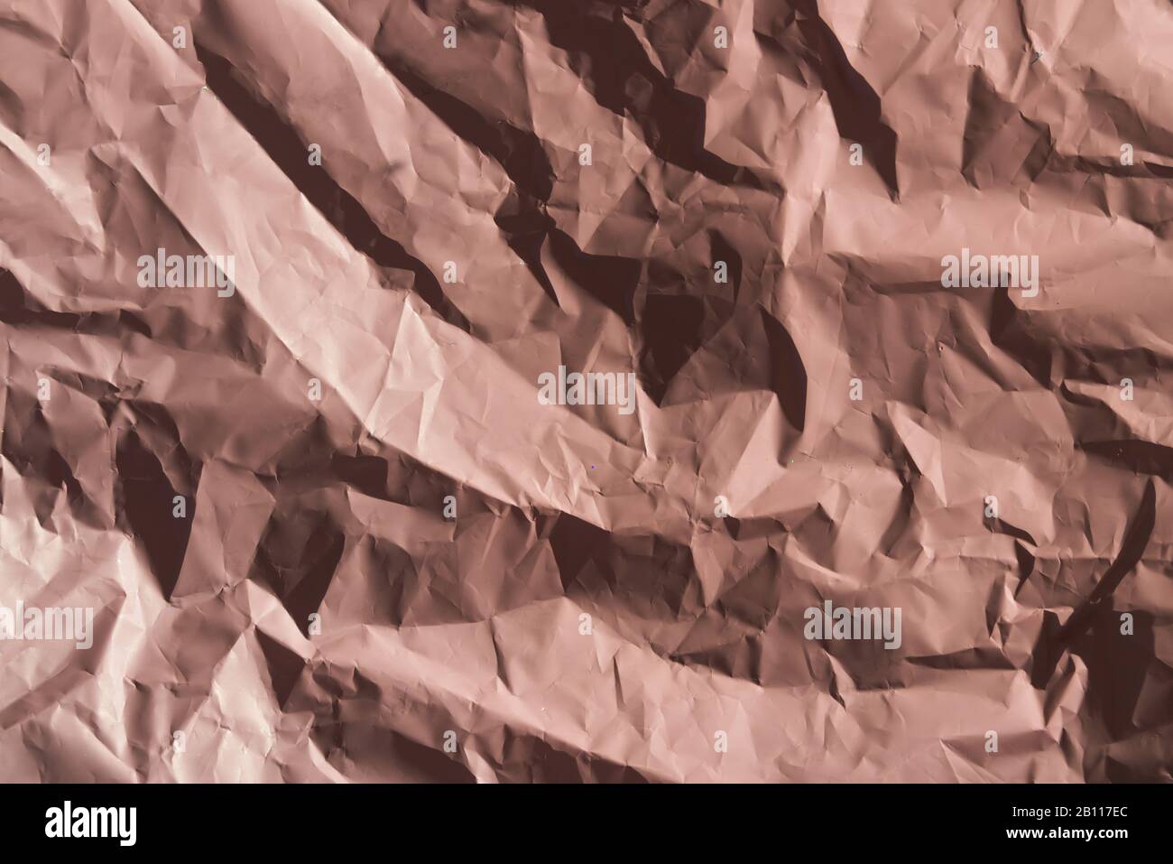 Crumpled craft wrapping paper with hard shadows. Close up, top view ...