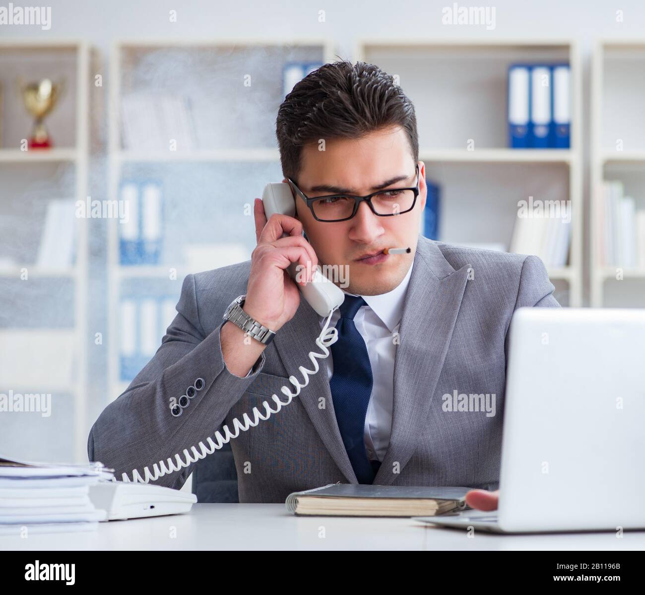 The businessman smoking in office at work Stock Photo - Alamy