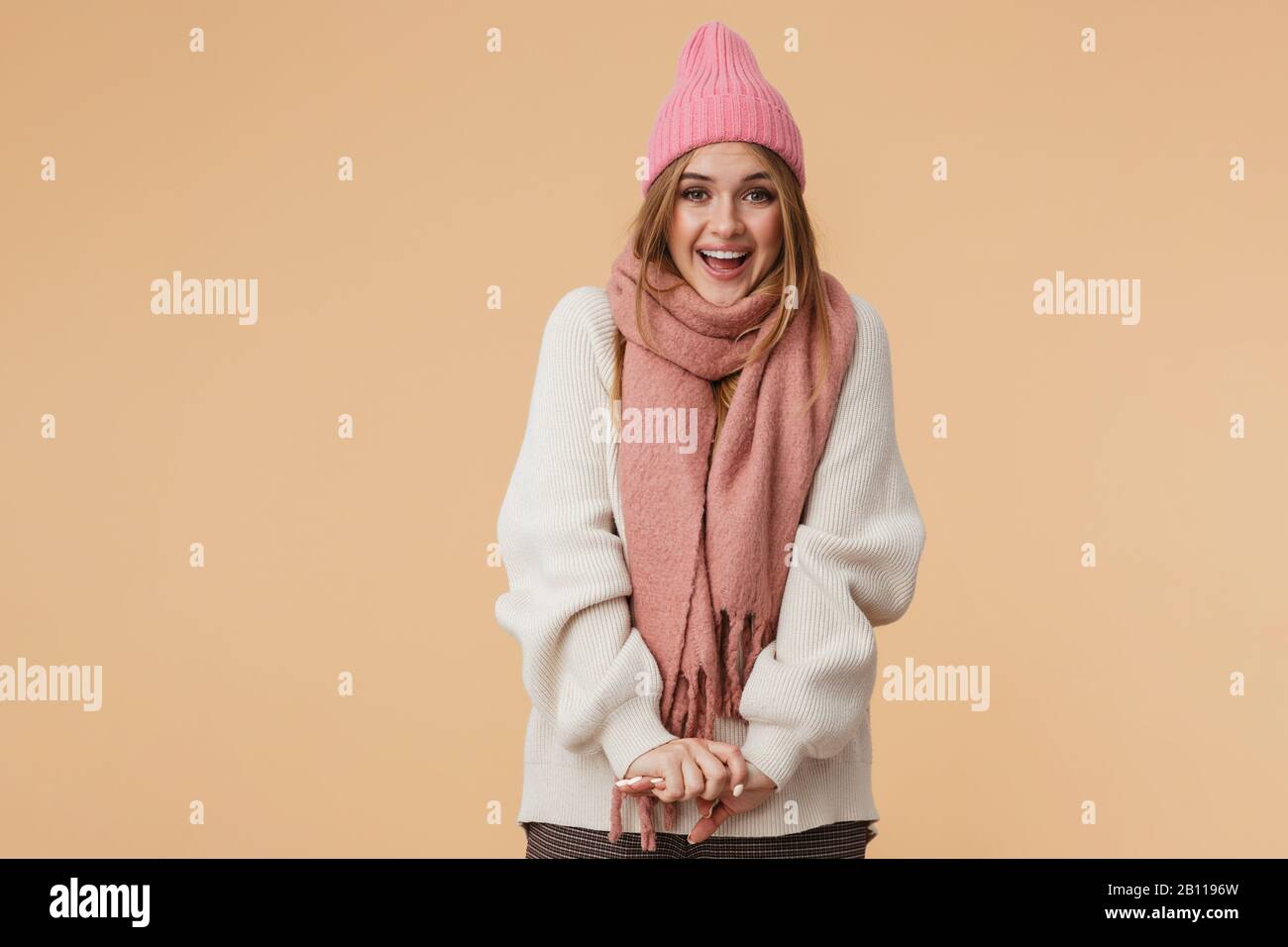 Image of young attractive girl wearing winter hat and scarf smiling and ...