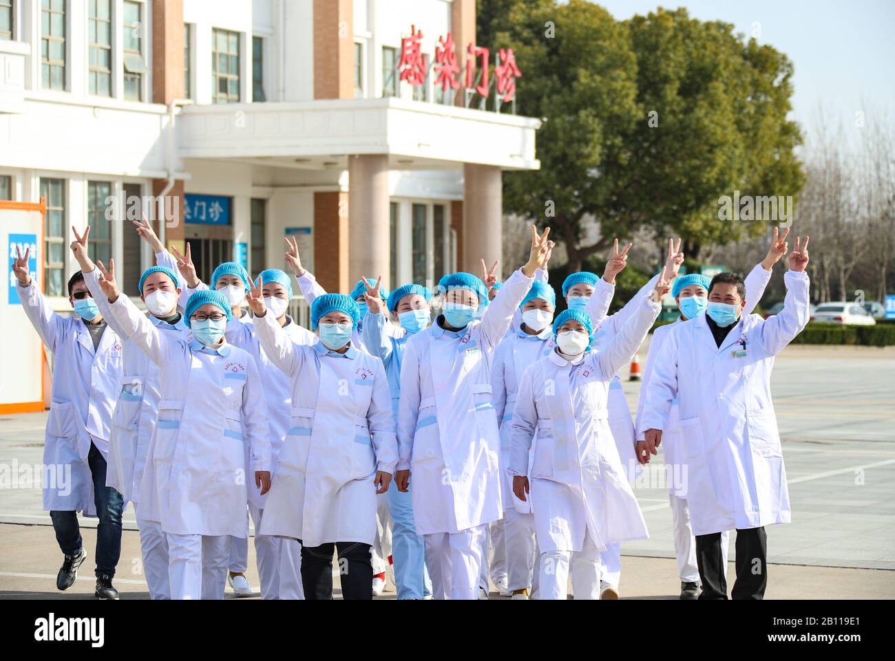 Masked Chinese medical workers show victory signs as they go back to ...