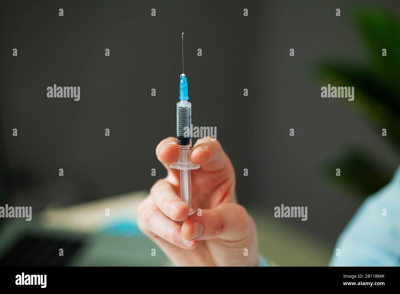 Doctor holding medical injection syringe in clinic Stock Photo - Alamy