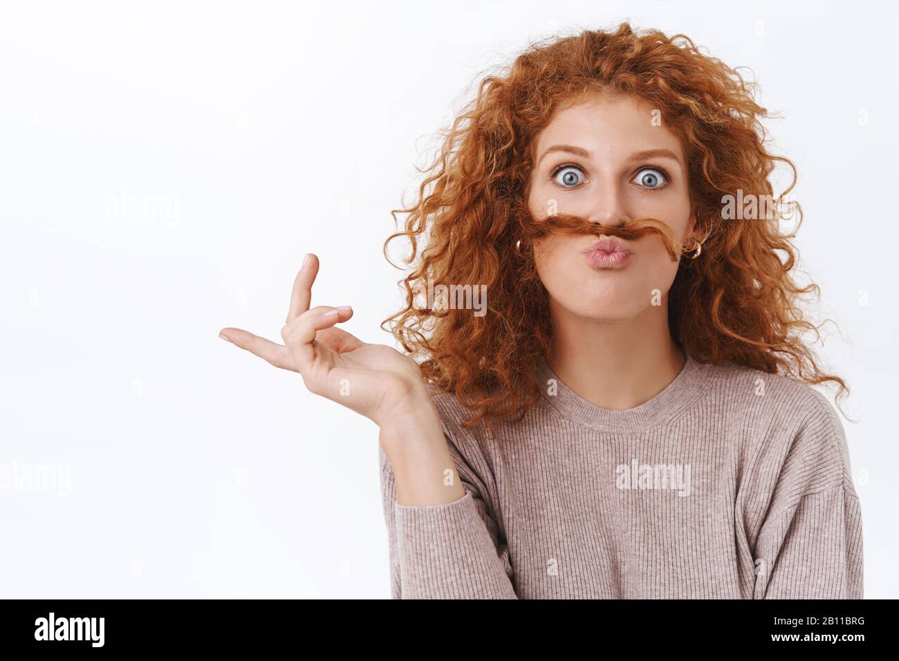 Close-up portrait playful, funny gorgeous redhead curly woman making ...
