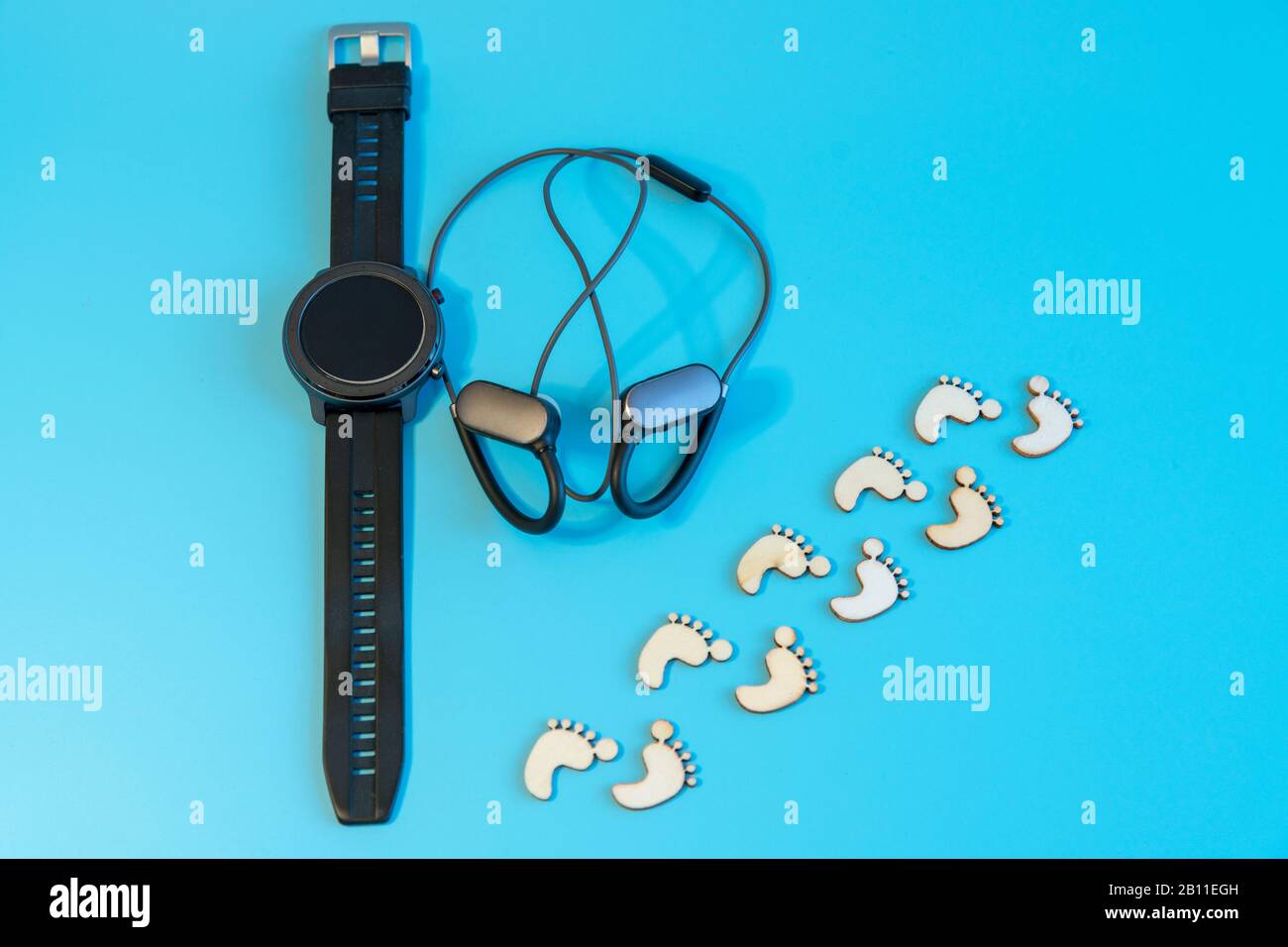 Running and healthy lifestyle concept. Fitness watch, headphones and ...