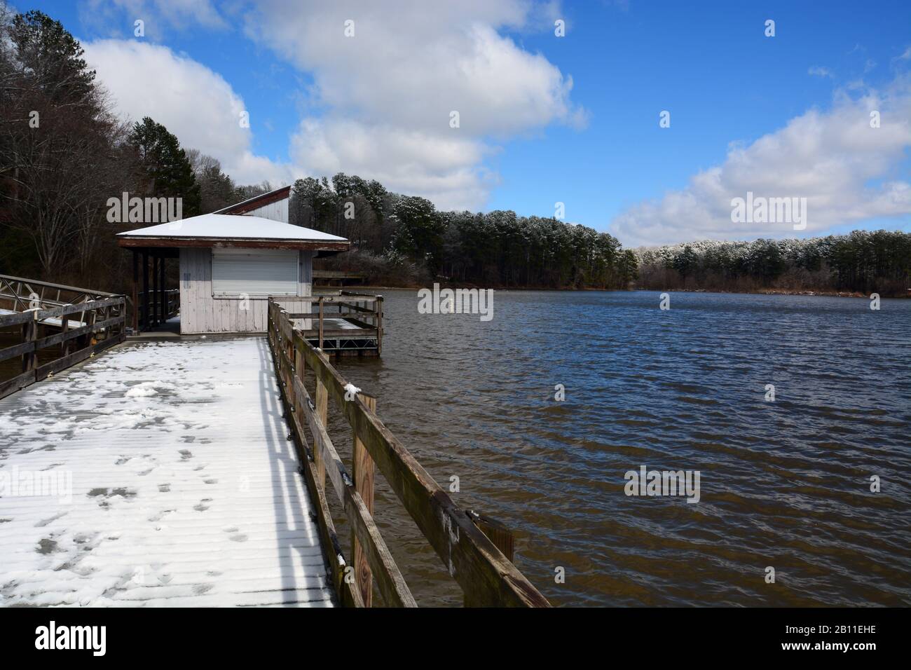 A fresh snowfall coats the fishing dock at Shelley Lake Park in Raleigh ...