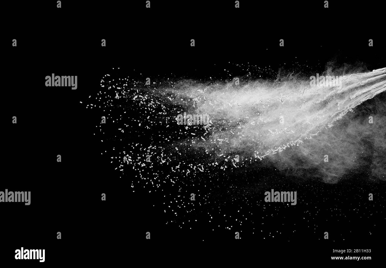 Freeze motion of white dust particles splash on black background.White ...
