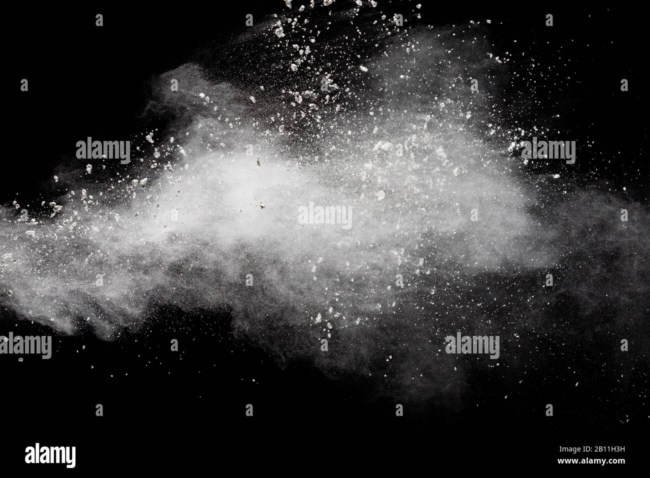 Freeze motion of white dust particles splash on black background.White ...