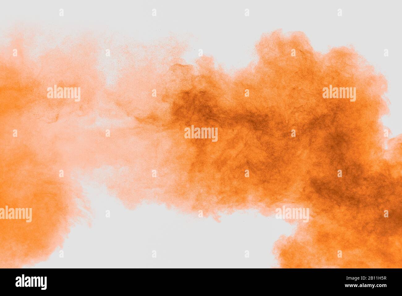 Orange color powder explosion on white background Stock Photo - Alamy