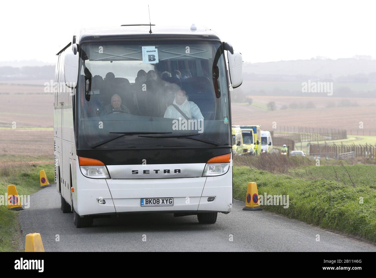 Passengers in coaches leave MoD Boscombe Down in Wiltshire after being ...