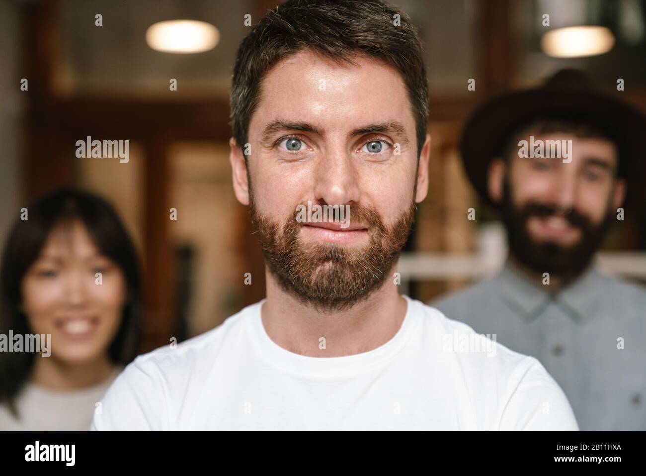 Image of multiethnic young female and male business workers standing ...