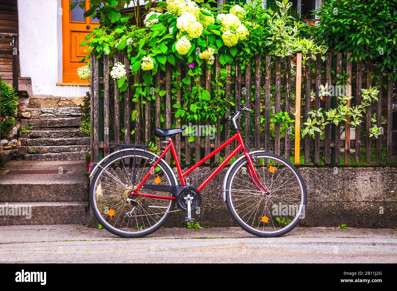 Red bicycle on fence hi-res stock photography and images - Alamy