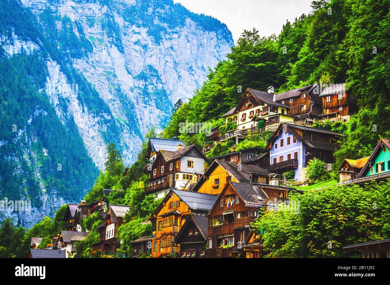 Typical austrian houses standing on the mountain hillside in Alps ...