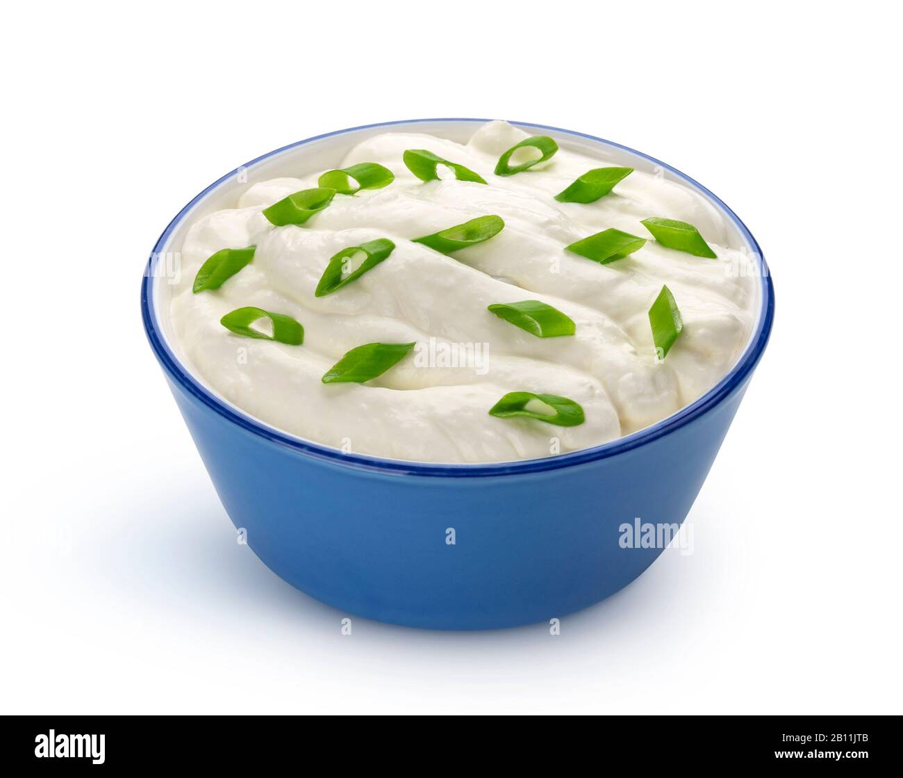 Sour cream with onion in blue bowl isolated on white background with ...