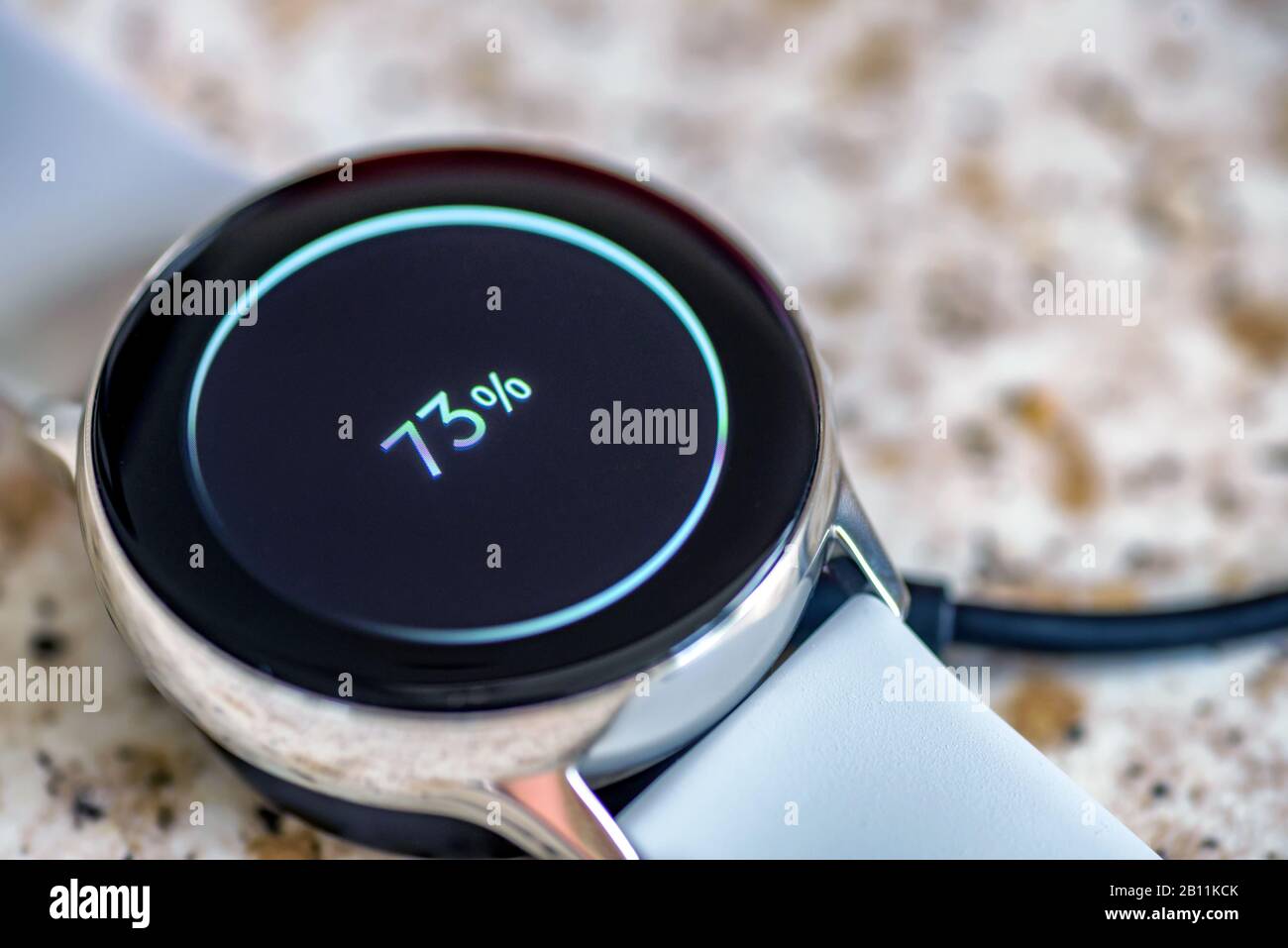 smart watch wireless charging on charging pad on kitchen worktop table ...