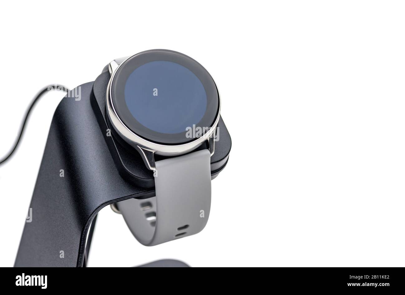 smart watch charging on wireless charging stand pad on white background ...