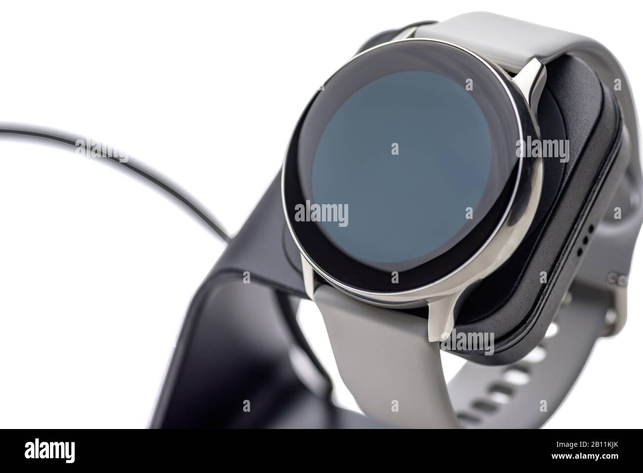 smart watch charging on wireless charging stand pad on white background ...