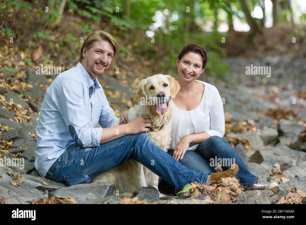 Couple sitting in the forest with labrador hi-res stock photography and ...