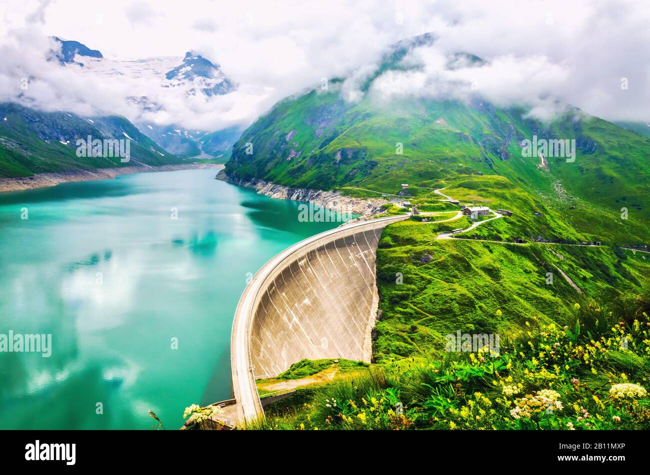 Hydroelectric power station at high mountains in clouds. Kaprun dam ...