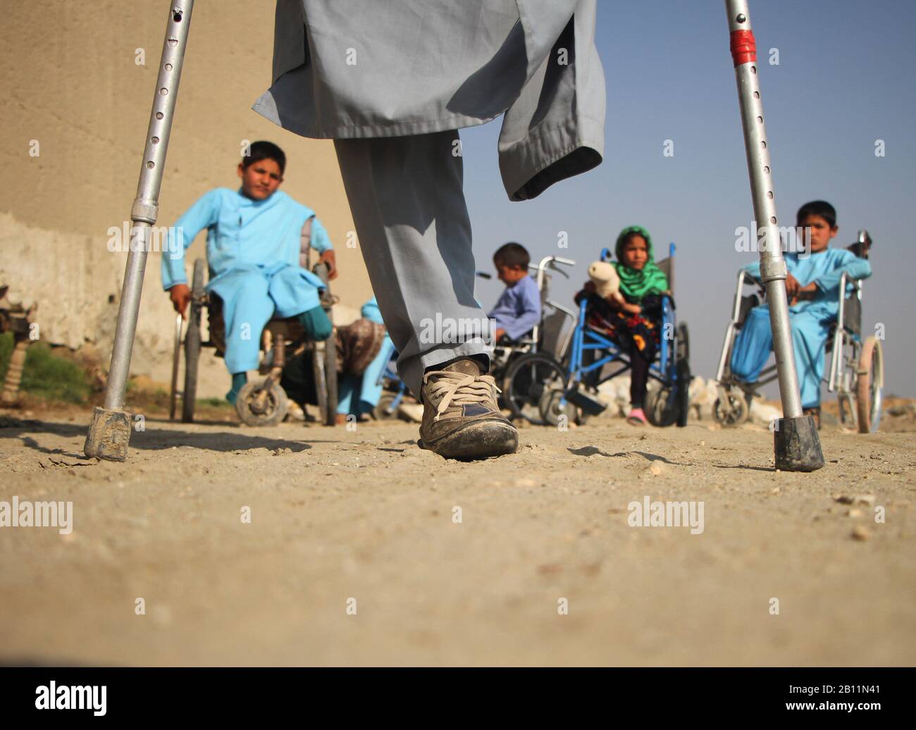 Jalalabad, Afghanistan. 22nd Feb, 2020. An Afghan disabled child walks ...
