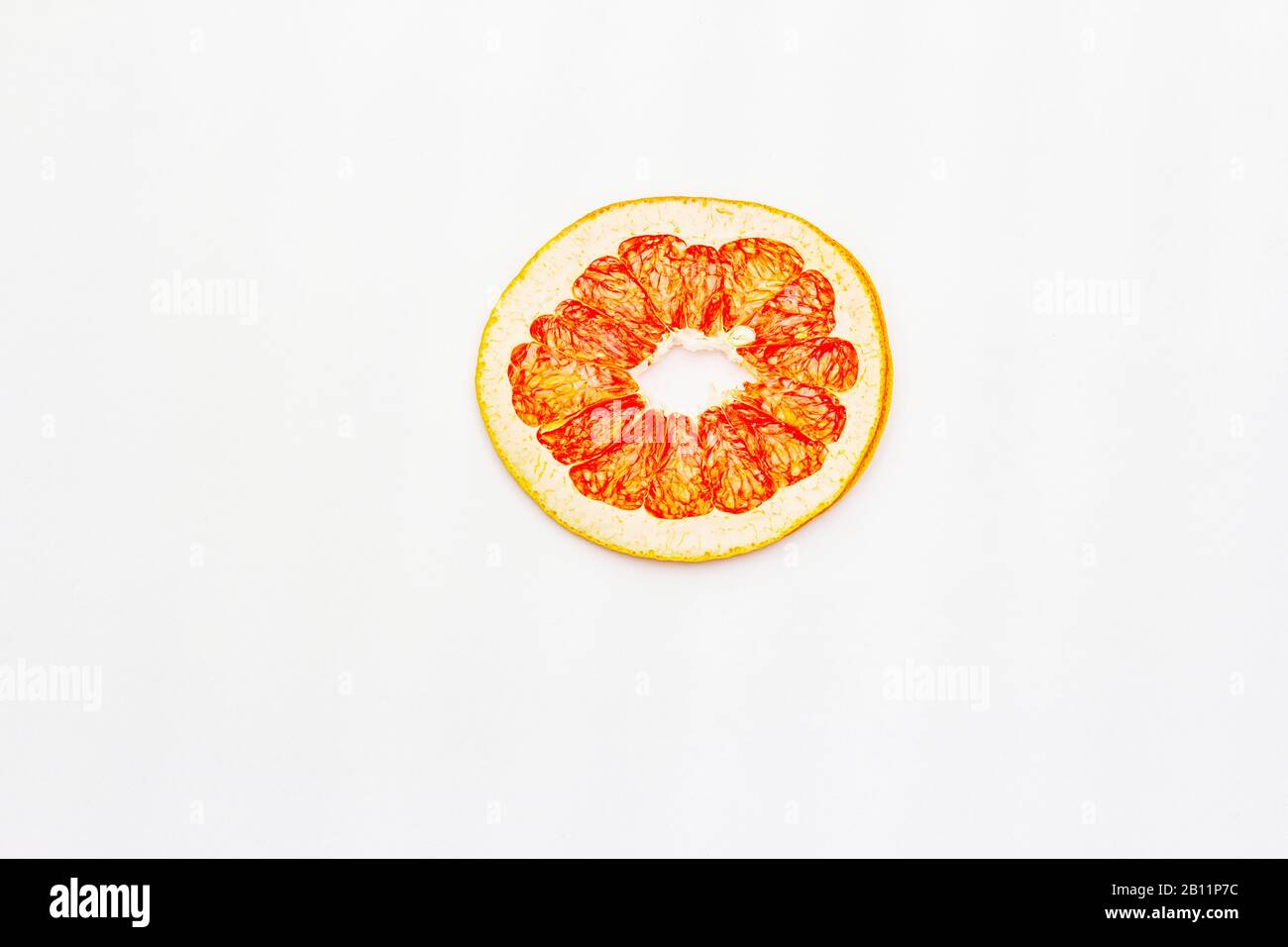 Dried single slice of grapefruit isolated on white background. Healthy ...