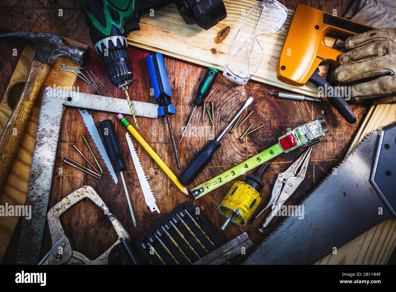 Wood tabletop work bench of tools, handsaw, tape measure, screw driver ...