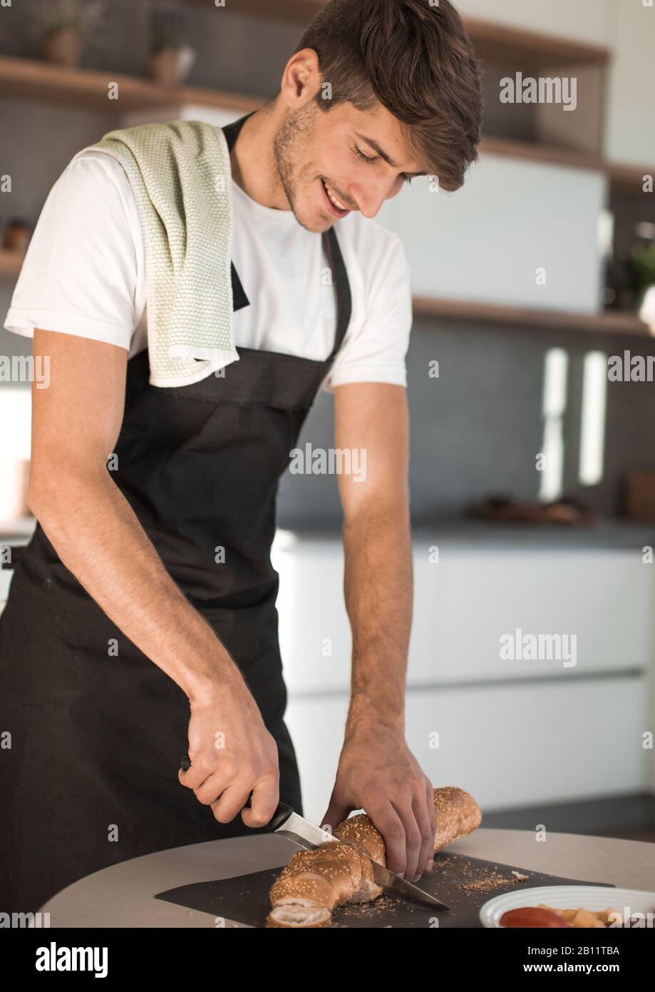 young man preparing a sandwich in the kitchen Stock Photo - Alamy