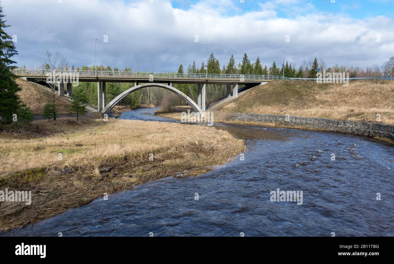 spring landscape with arched bridge over the river, Salaca near Melturi ...