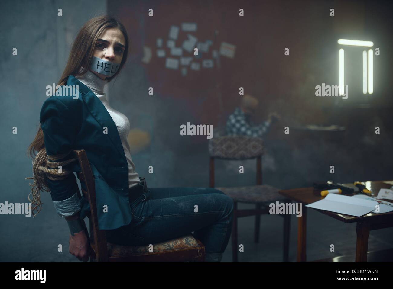 Female victim with taped mouth, maniac kidnapper Stock Photo - Alamy