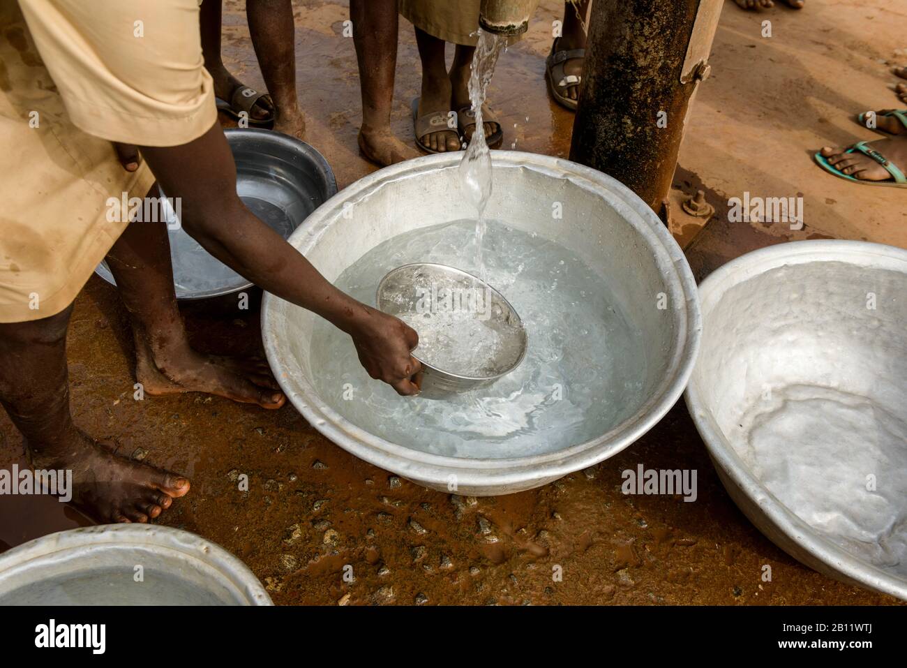 Collecting water in North Benin, Africa Stock Photo - Alamy