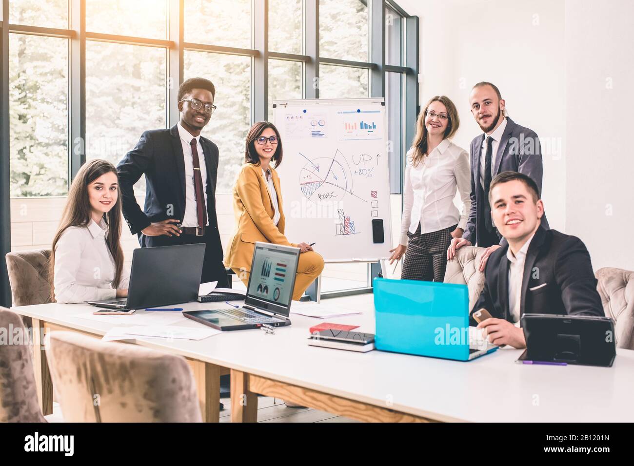 Business people doing statistics presentation inside a building. Happy ...