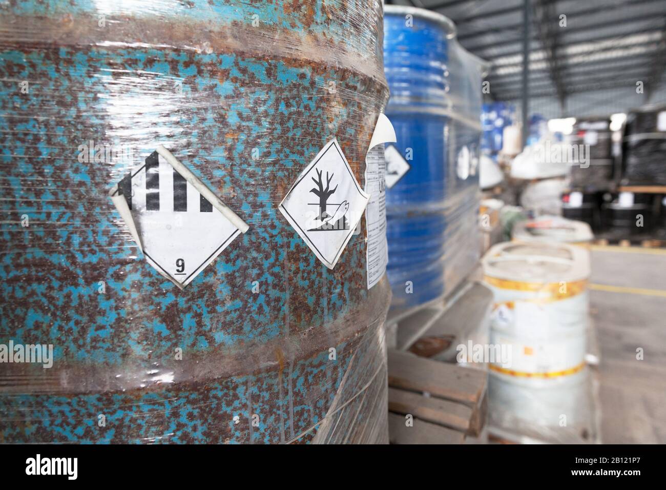 Waste barrel with hazard warning symbol in the warehouse Stock Photo ...