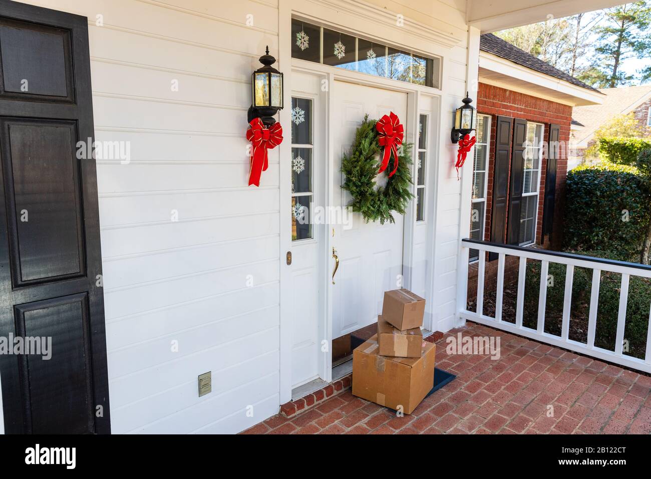 Packages on front porch of home during holiday season Stock Photo - Alamy