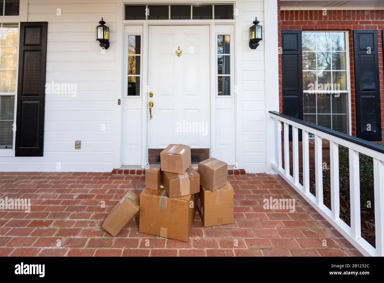 Shipping boxes on front porch of home Stock Photo - Alamy