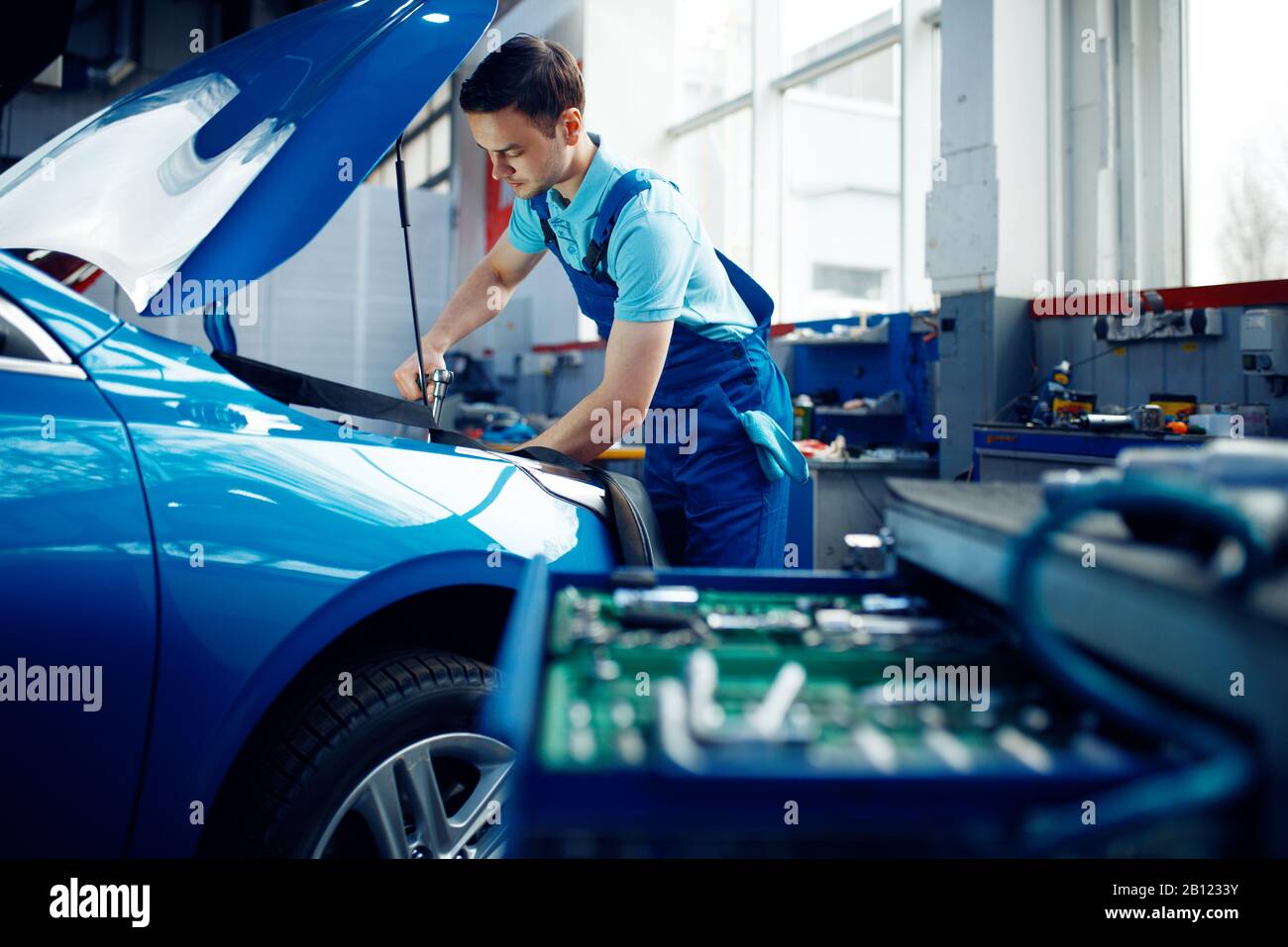 Mechanic checks engine oil hi-res stock photography and images - Alamy