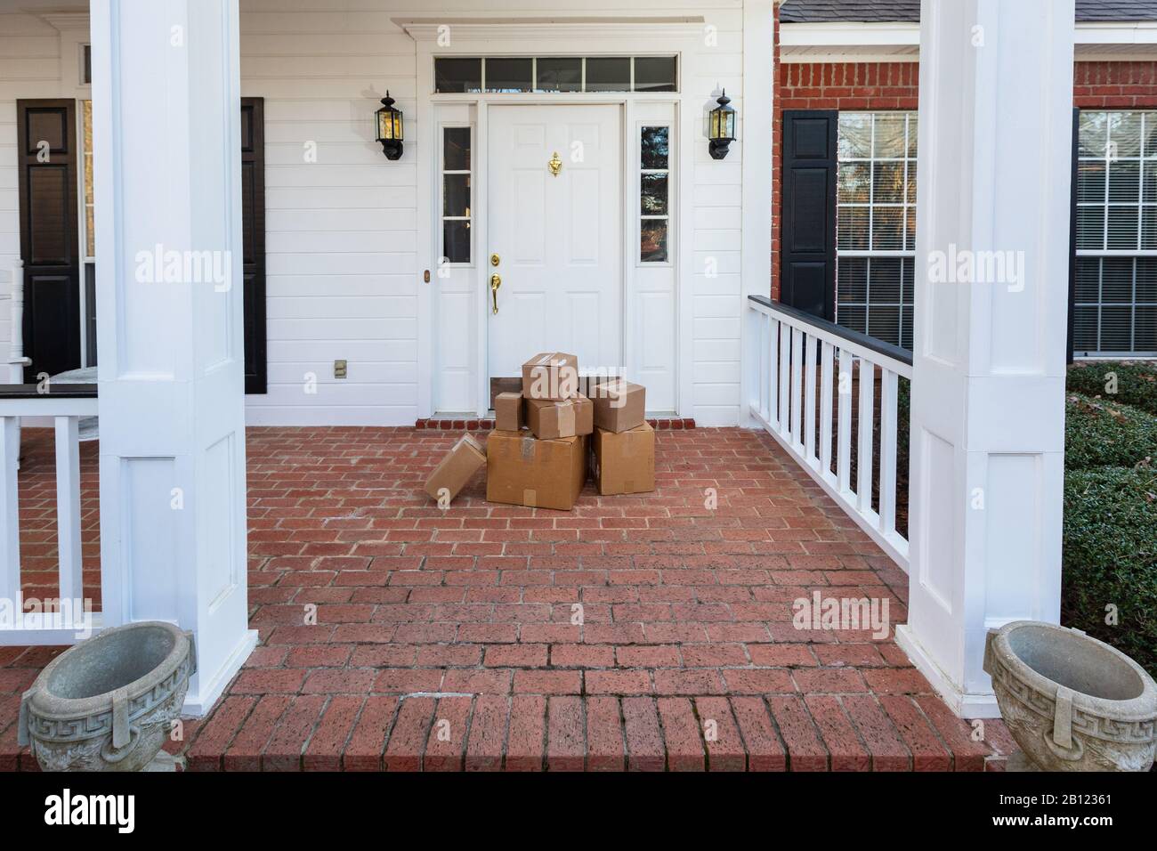 Shipping boxes on front porch of home Stock Photo - Alamy