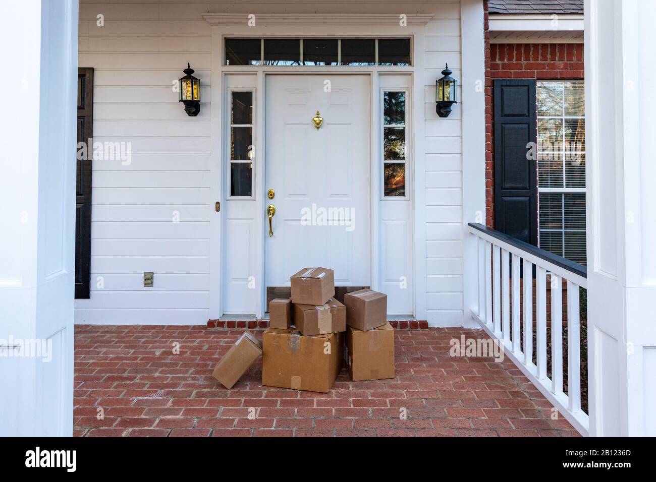 Shipping boxes on front porch of home Stock Photo - Alamy
