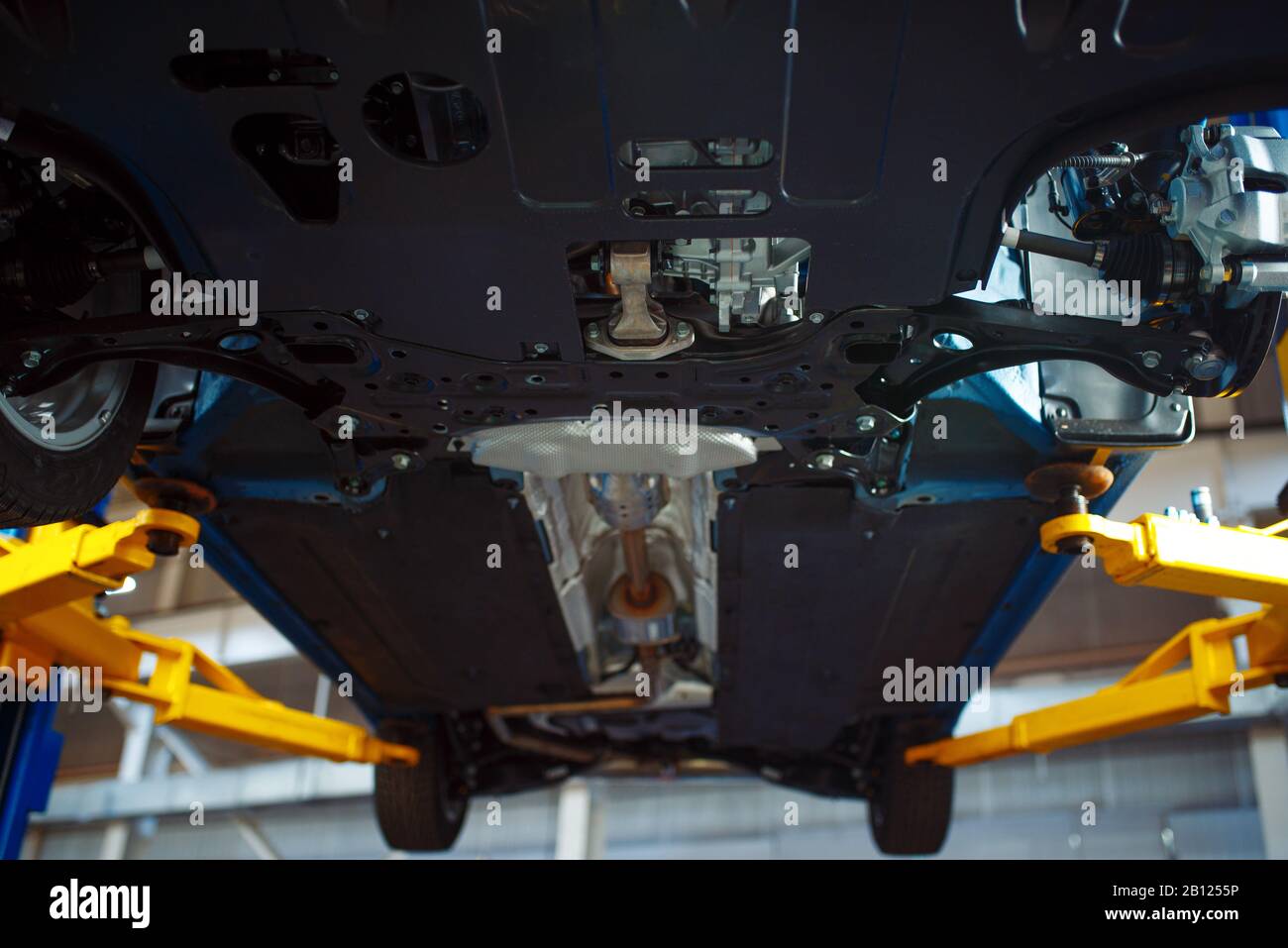 Vehicle on lift, bottom view, car service station Stock Photo - Alamy