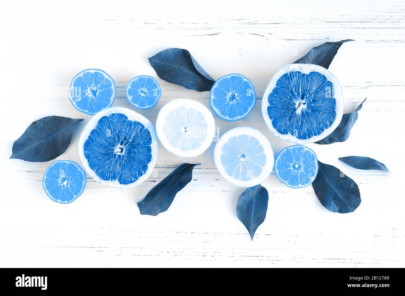 Mixed citrus background. Assorted fresh citrus fruits with leaves on ...