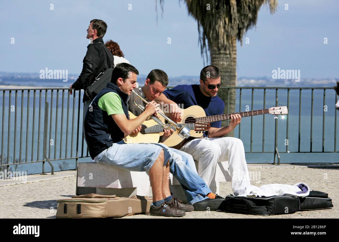 Tree man plays guitar and trumpet on Portas do Sol Square Stock Photo ...