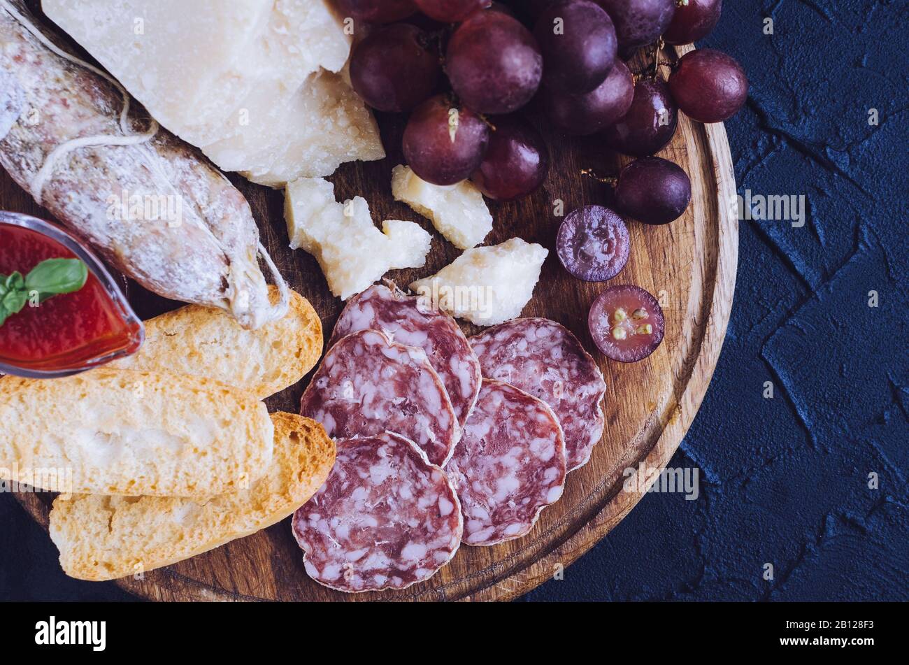 Board with mediterranean appetizers, tapas or antipasti. Assorted ...