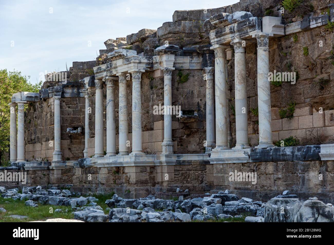 A side view of ancient ruins of the old city in Side, Turkey. Colossal ...