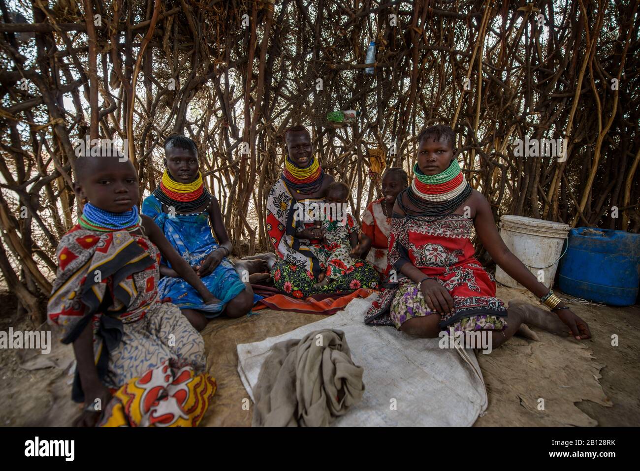 Turkana women wear their traditional necklaces, inside their hut made ...
