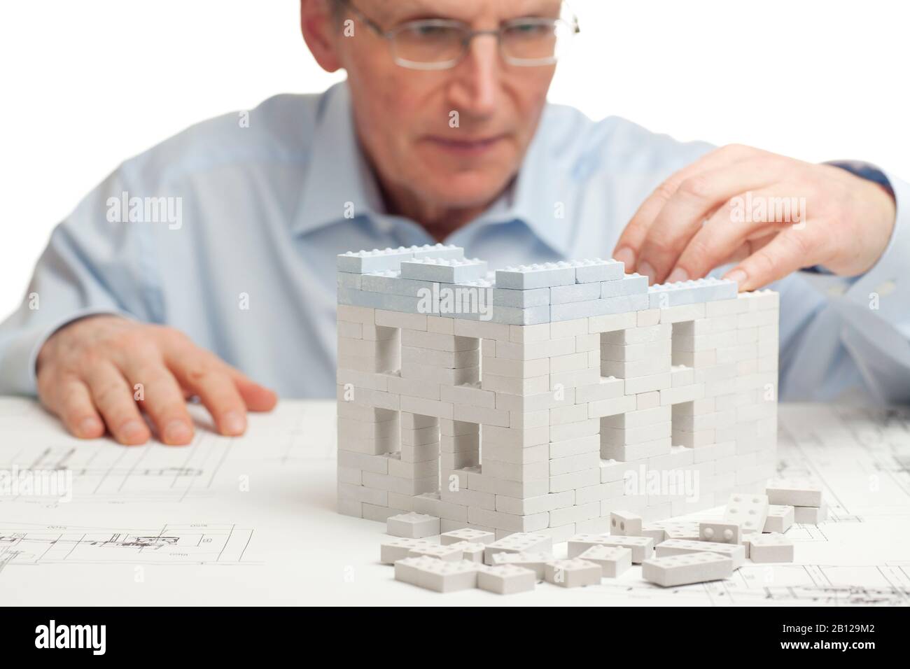 Architect constructing a house - white background Stock Photo - Alamy
