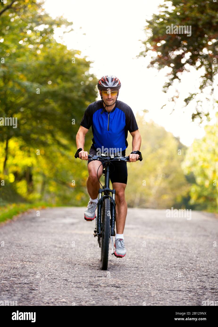 Sporty active man ride bike, mountain bike Stock Photo - Alamy