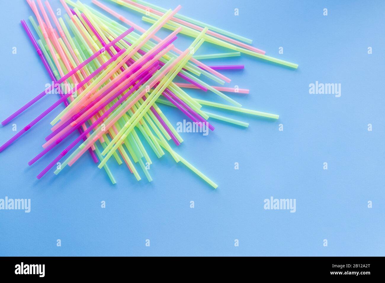 Colored plastic drinking straws on a blue background. Say no for ...