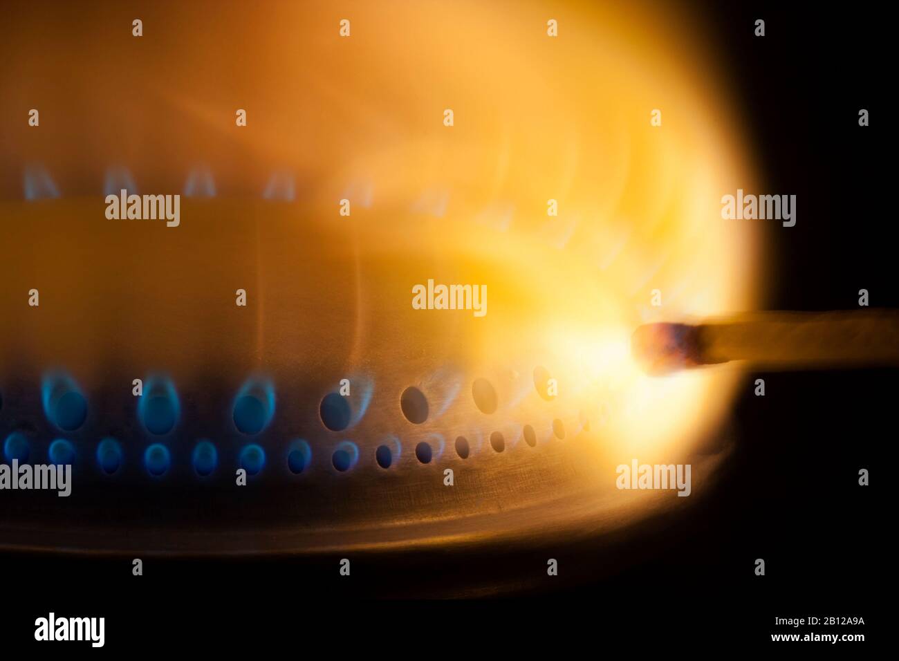 Close-up of a match inflaming a gas stove Stock Photo - Alamy