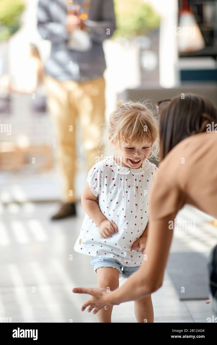 Happy child girl with family at shopping in store Stock Photo - Alamy