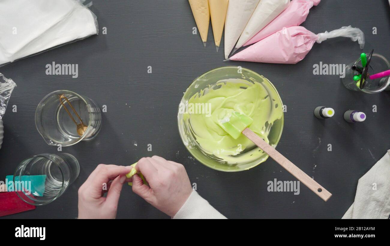 Step by step. Flat lay. Pouring royal icing into the piping bag to ...