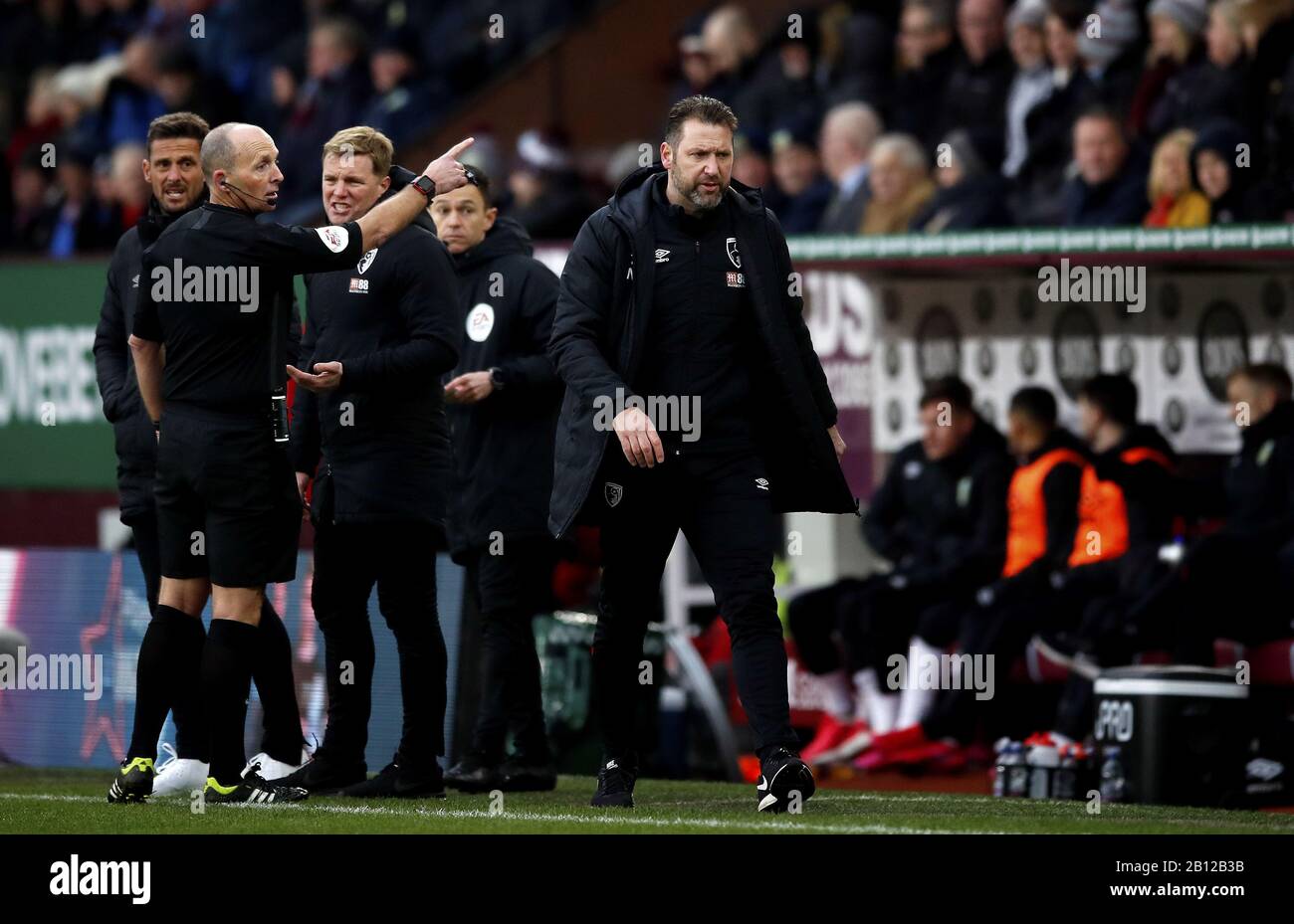 Bournemouth goalkeeper coach Neil Moss (right) walks off from referee ...