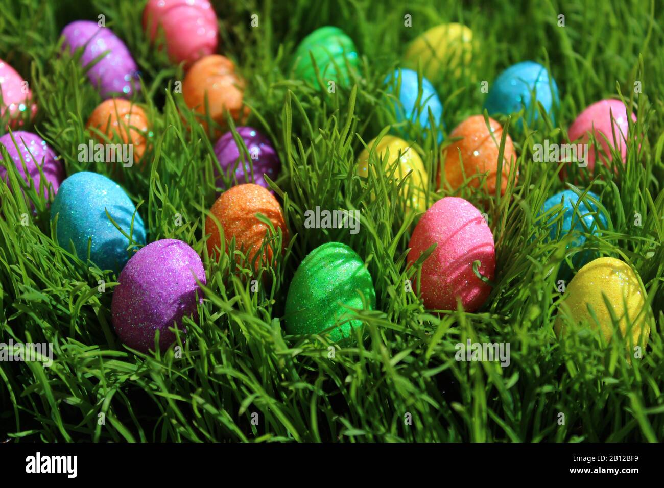 The picture shows colourful eastereggs in eastergrass Stock Photo - Alamy
