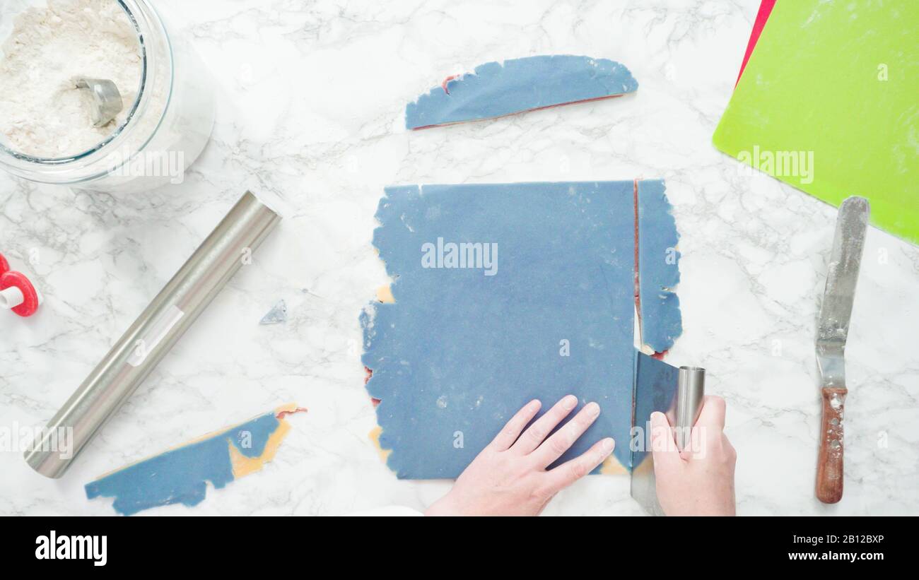 Step by step. Flat lay. Rolling out dough with a rolling pin to bake ...